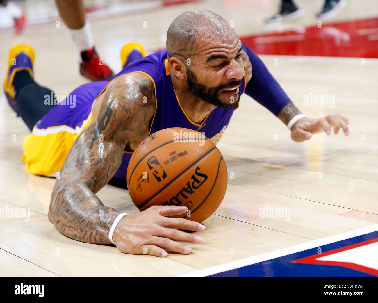 Los Angeles Lakers forward Carlos Boozer dives for a loose ball in the ...