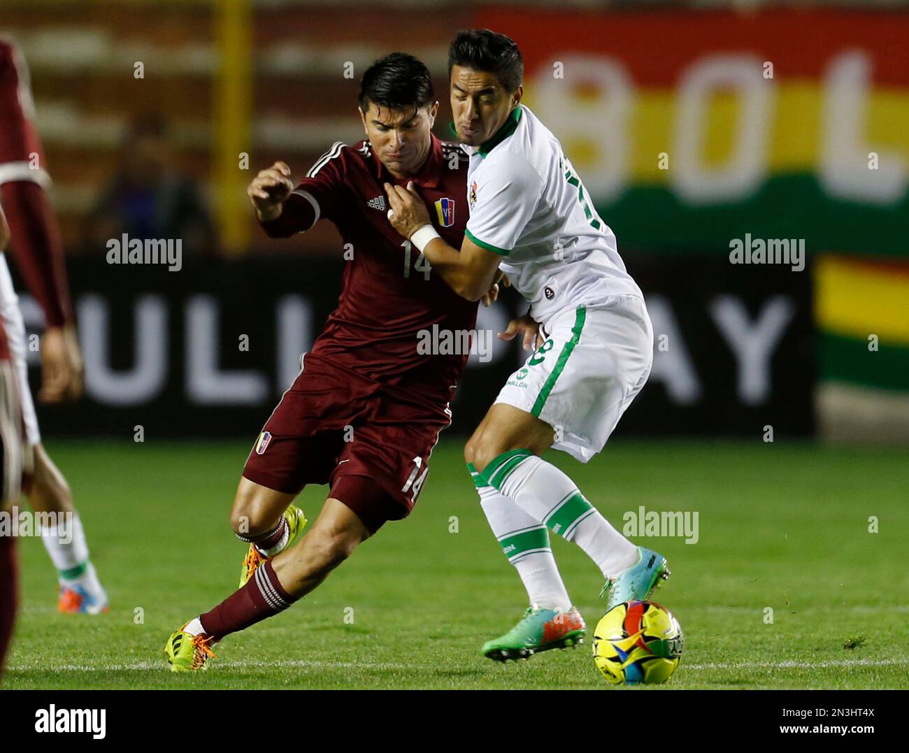 Bolivia's Rodrigo Ramallo, right, fights for the ball with Venezuela's ...
