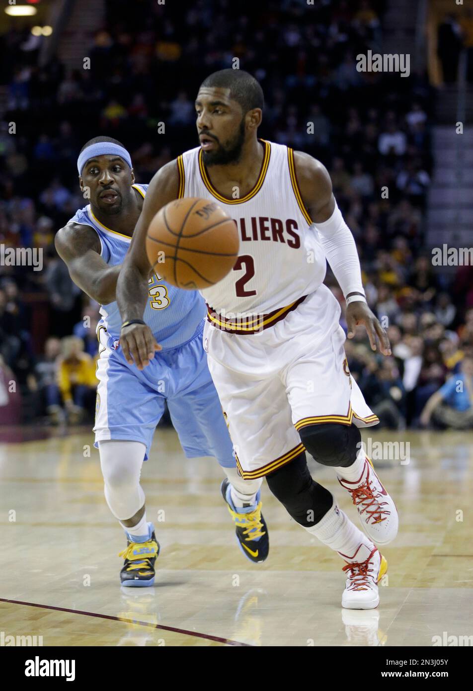 Cleveland Cavaliers' Kyrie Irving (2) drives past Denver Nuggets' Ty ...