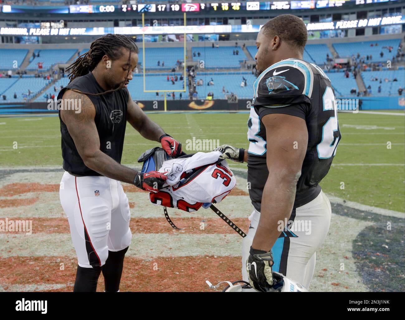 Atlanta Falcons' Charles Godfrey (30) gives his game jersey to the ...