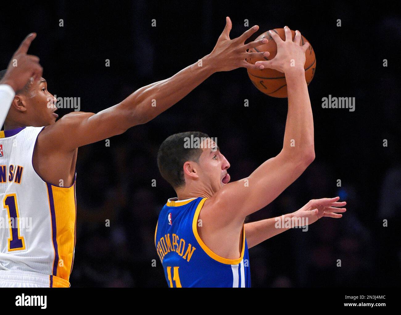 Golden State Warriors guard Klay Thompson, right, goes up for a shot as ...