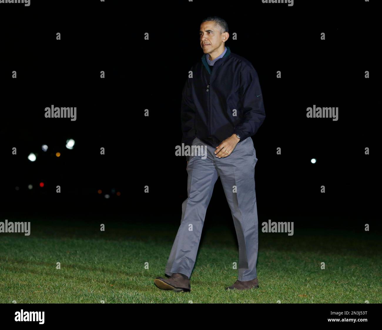 President Barack Obama walks across the South Lawn to the White House ...