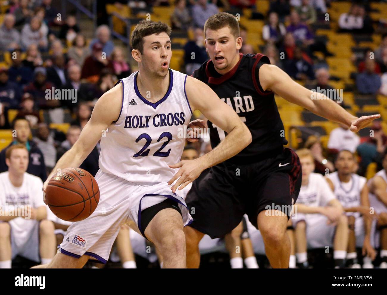 Holy Cross guard Robert Champion, left, tries to drive past Harvard ...