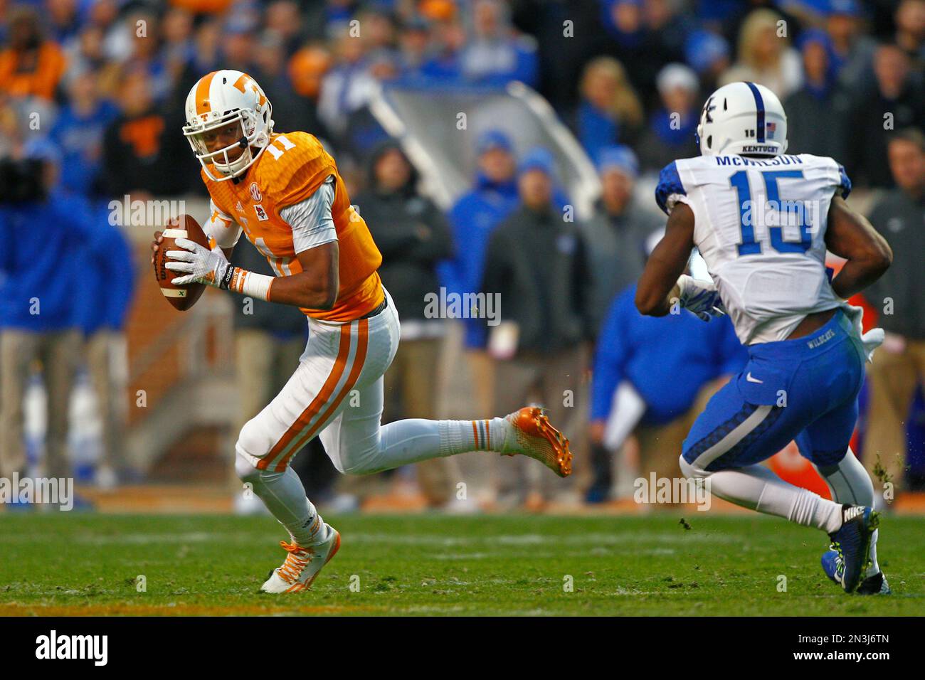 Tennessee quarterback Joshua Dobbs (11) runs away from Kentucky safety ...