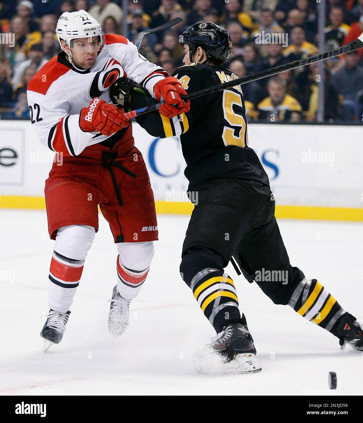 Boston Bruins' Adam McQuaid (54) keeps Carolina Hurricanes' Zach ...