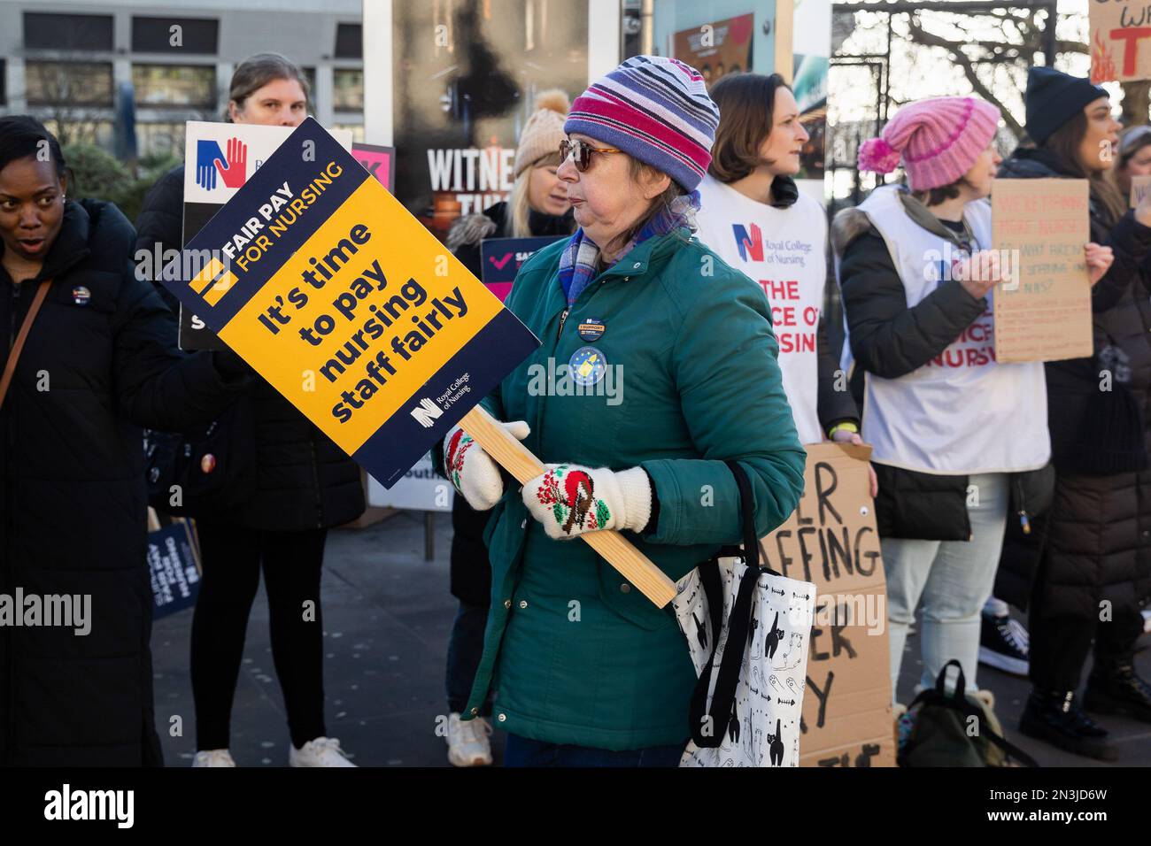 Nurses hold up placards expressing their opinion during the ...