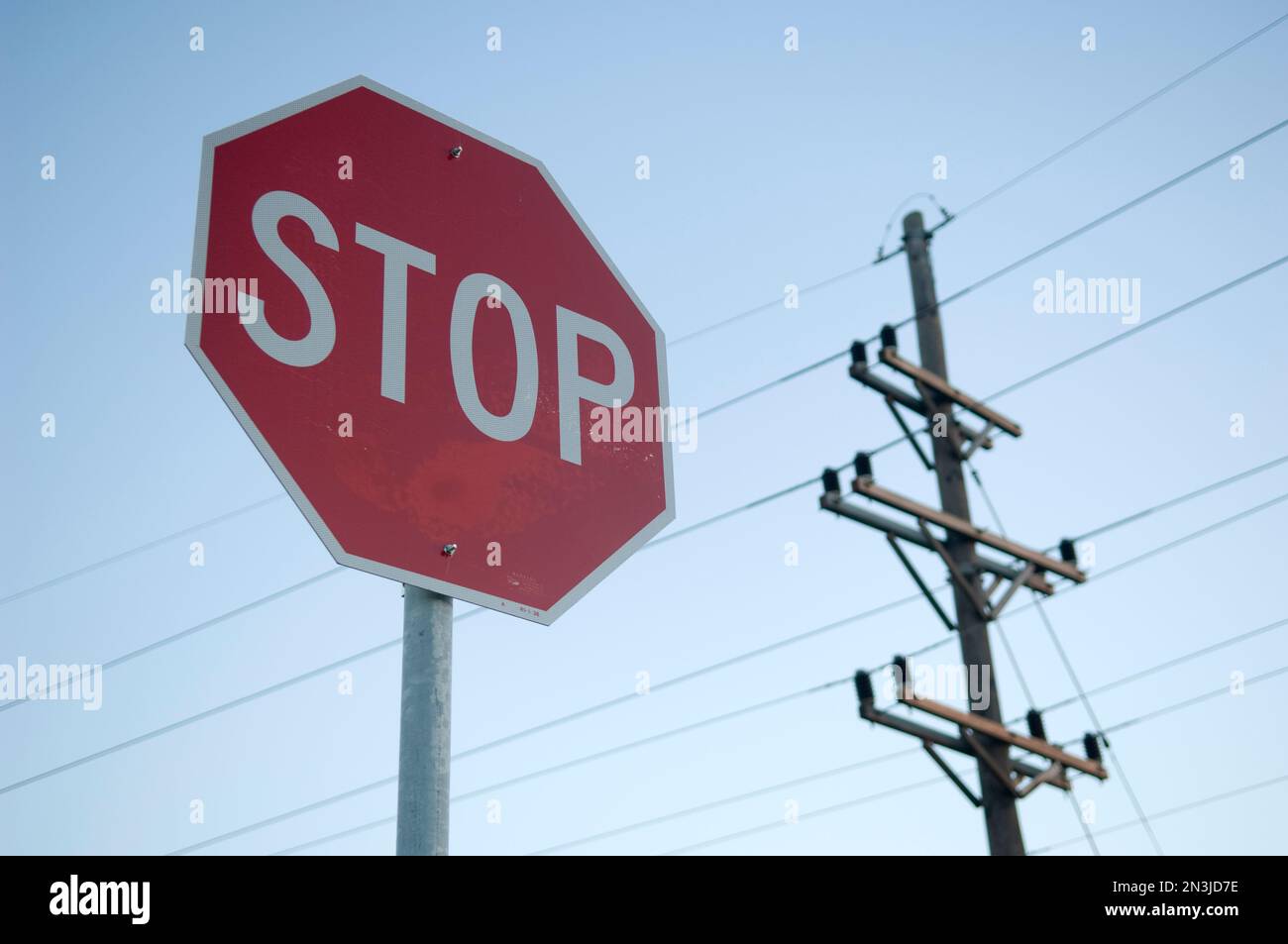 Red stop road sign with overhead power lines in the background; Mobile ...