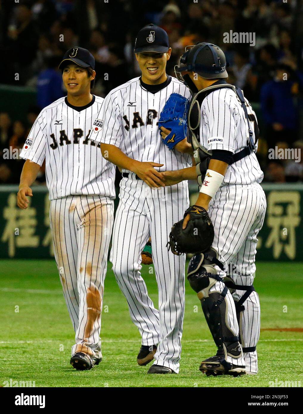 Japan's closer Yuji Nishino, center, celebrates with catcher Motohiro ...