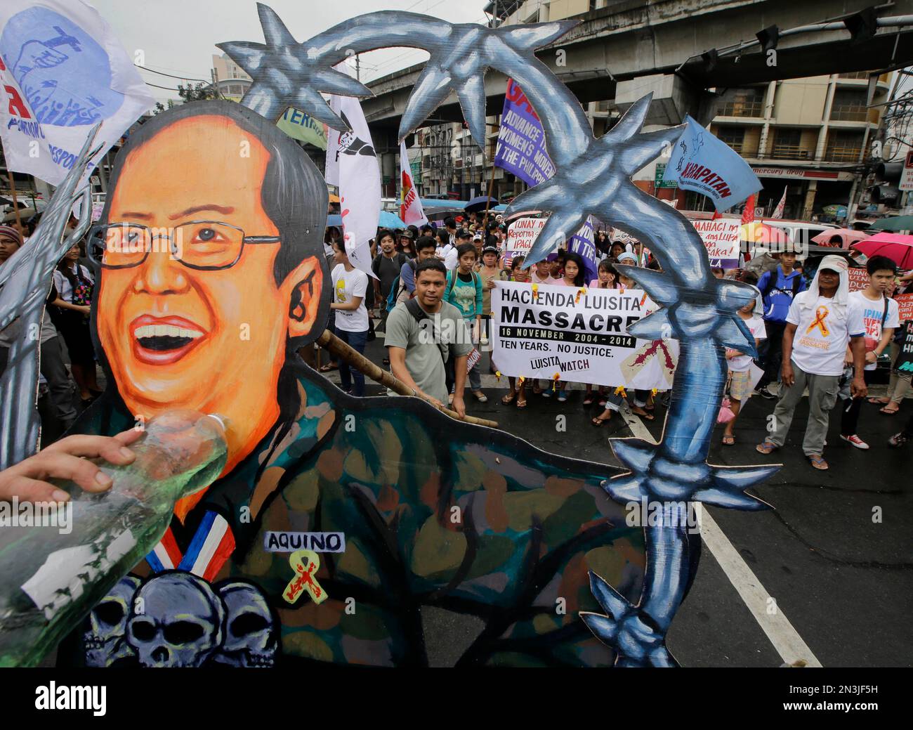 Protesters prepare to burn a cutout of Philippine President Benigno ...