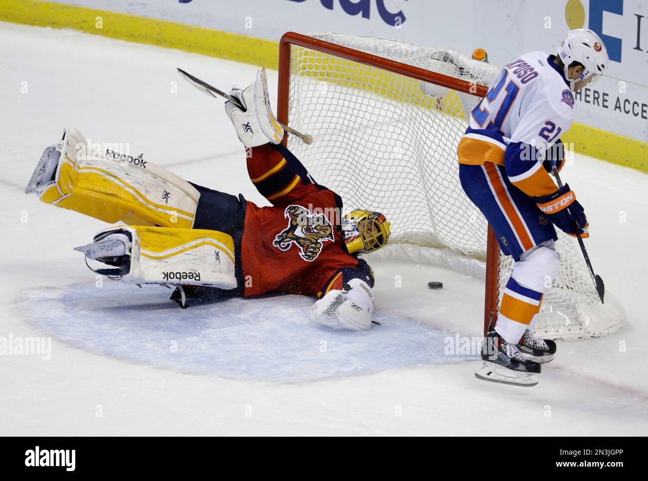 Florida Panthers goalie Roberto Luongo, left, falls to the ice after ...
