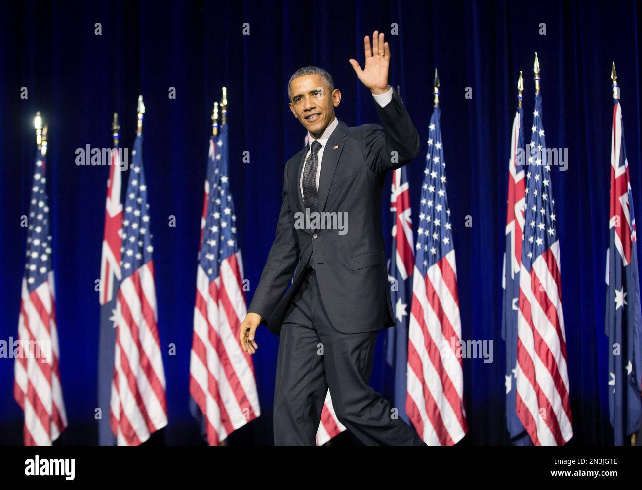 U.S. President Barack Obama waves as he walks on stage to speak at the ...