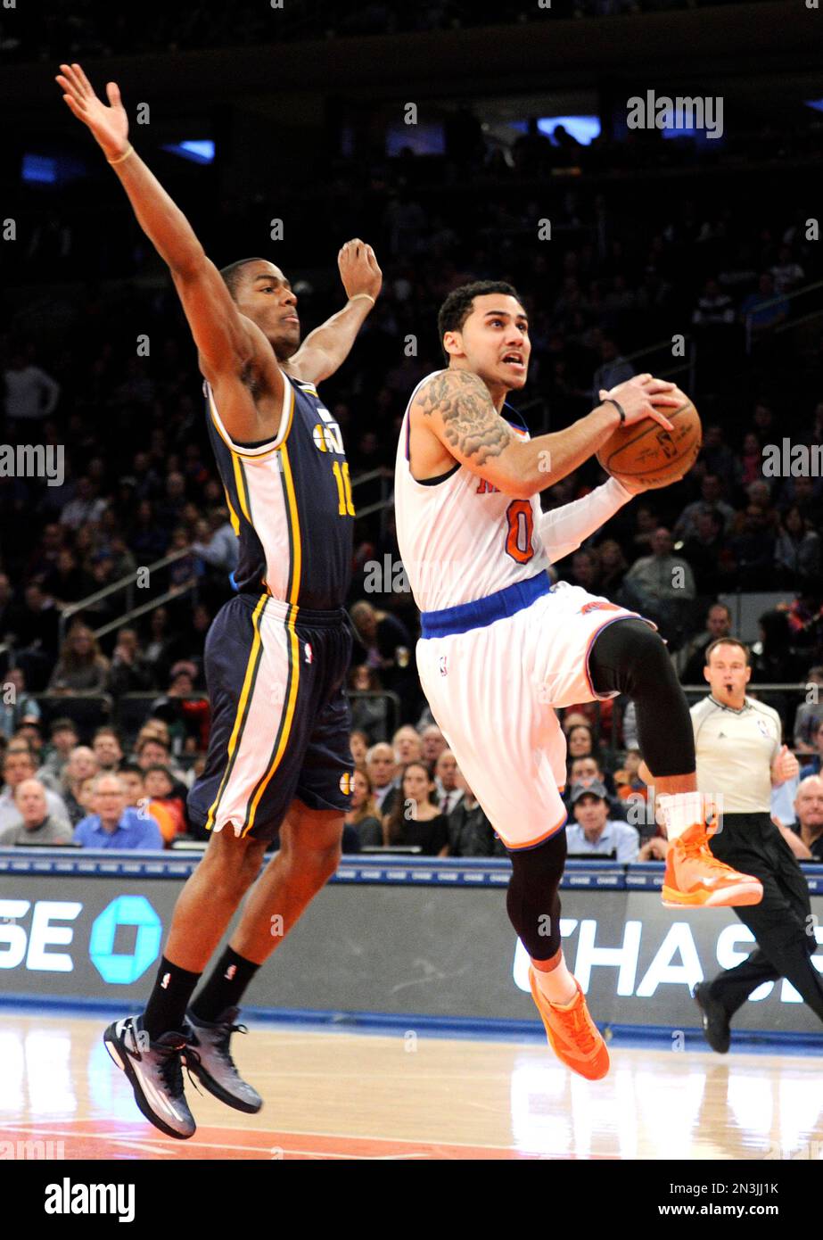 New York Knicks' guard Shane Larkin, right, drives to the basket as he ...