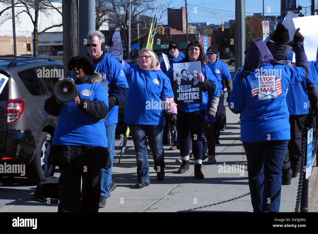 Postal workers take part in a protest on Friday, Nov. 14, 2014, against ...