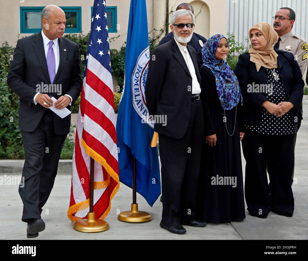 Homeland Security Secretary Jeh Johnson, left, walks to the podium past ...