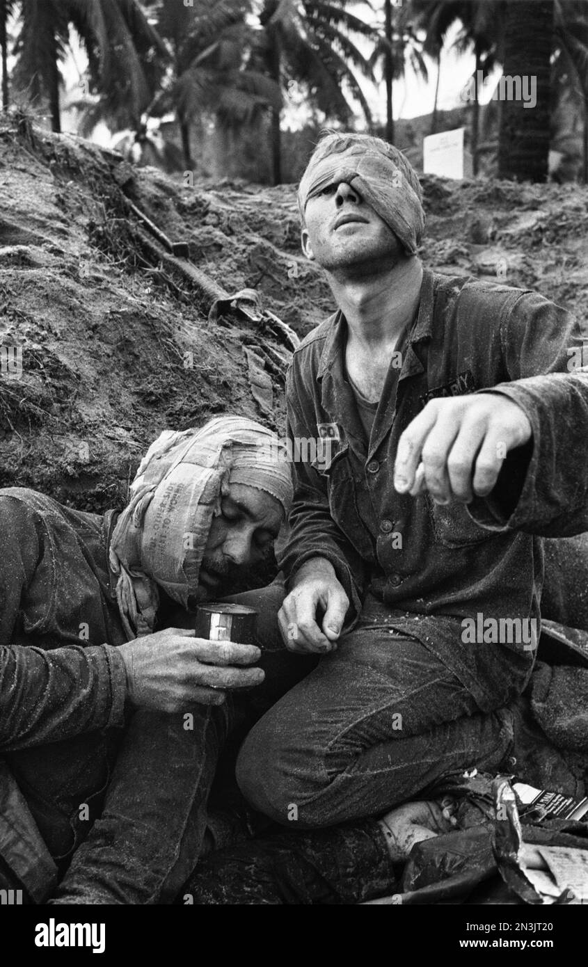 First Cavalry Division medic Thomas Cole, of Richmond, Va., right, with ...