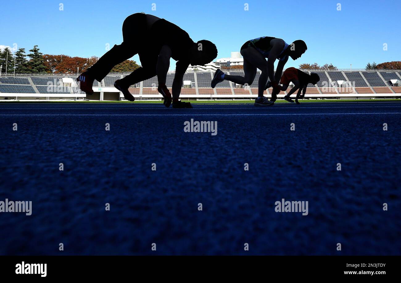 Competitors run on their arms and legs on a race course in a ...
