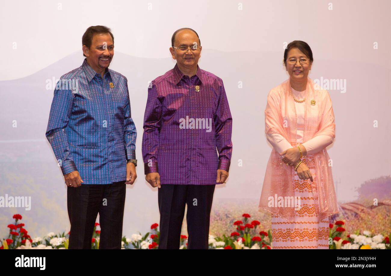 Myanmar President Thein Sein, center and his wife Khin Khin Win, right pose for a picture with ...