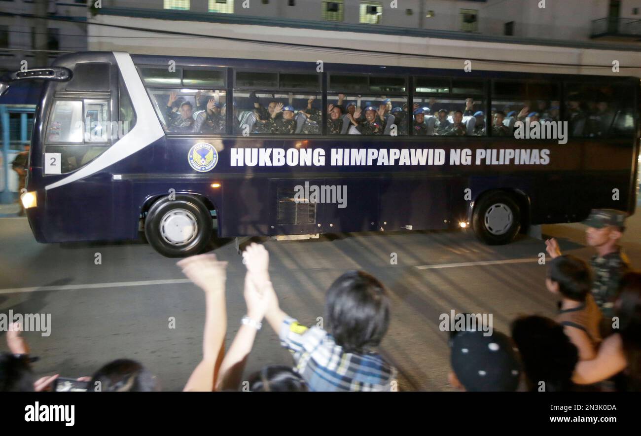 Relatives wave as more than 130 Filipino soldiers and police, onboard ...