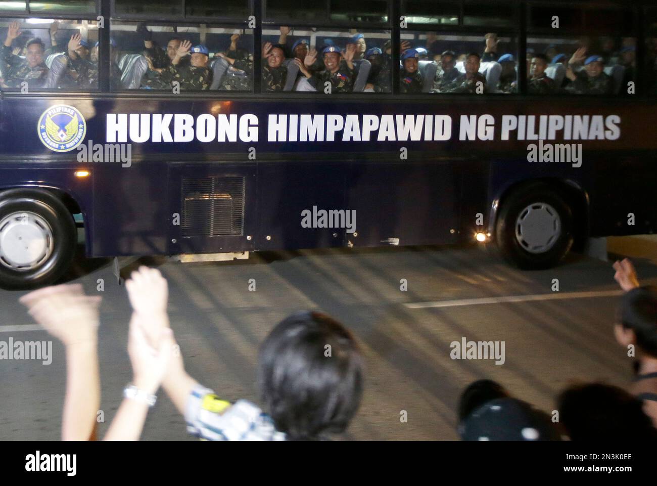 Relatives wave as more than 130 Filipino soldiers and police, onboard ...
