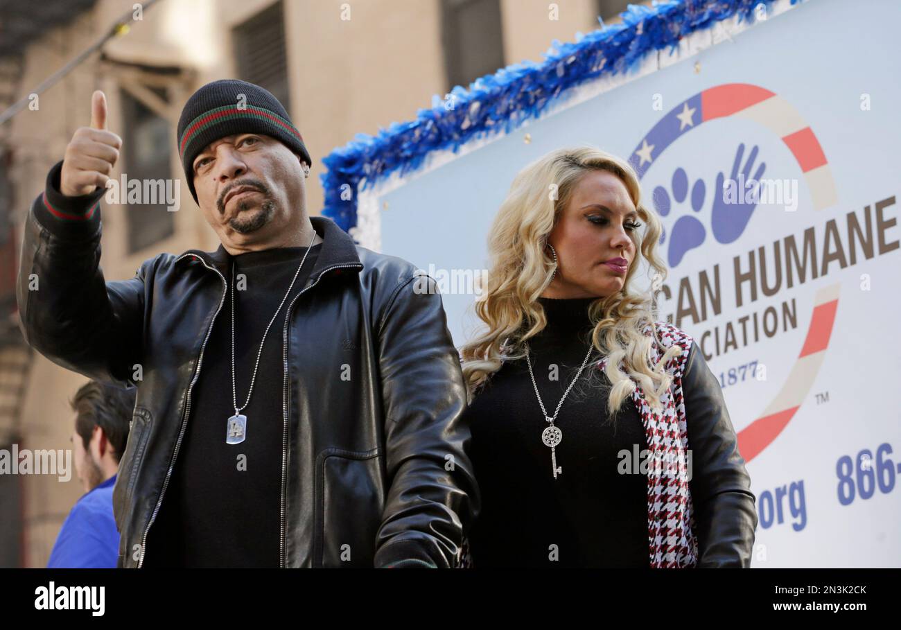 Rapper Ice-T smiles as his wife Coco waves at spectators as they ride ...