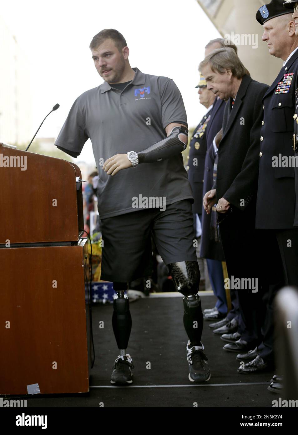 Retired US Army Staff Sgt. Travis Mills, left, of the 82nd Airborne ...