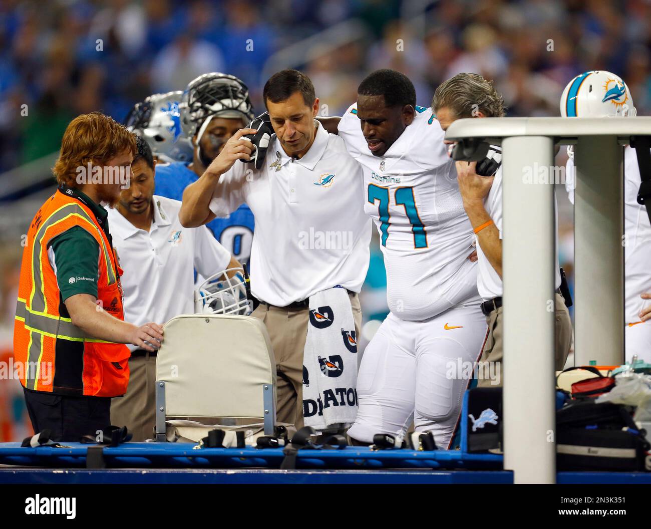 Miami Dolphins tackle Branden Albert (71) is helped to the cart after ...