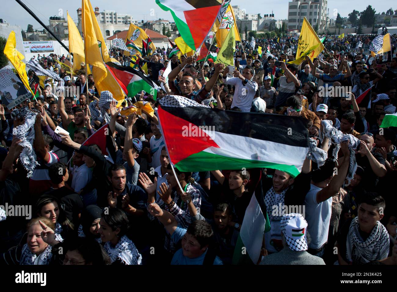 Palestinian supporters fly Palestinian and Fatah party flags, chant ...