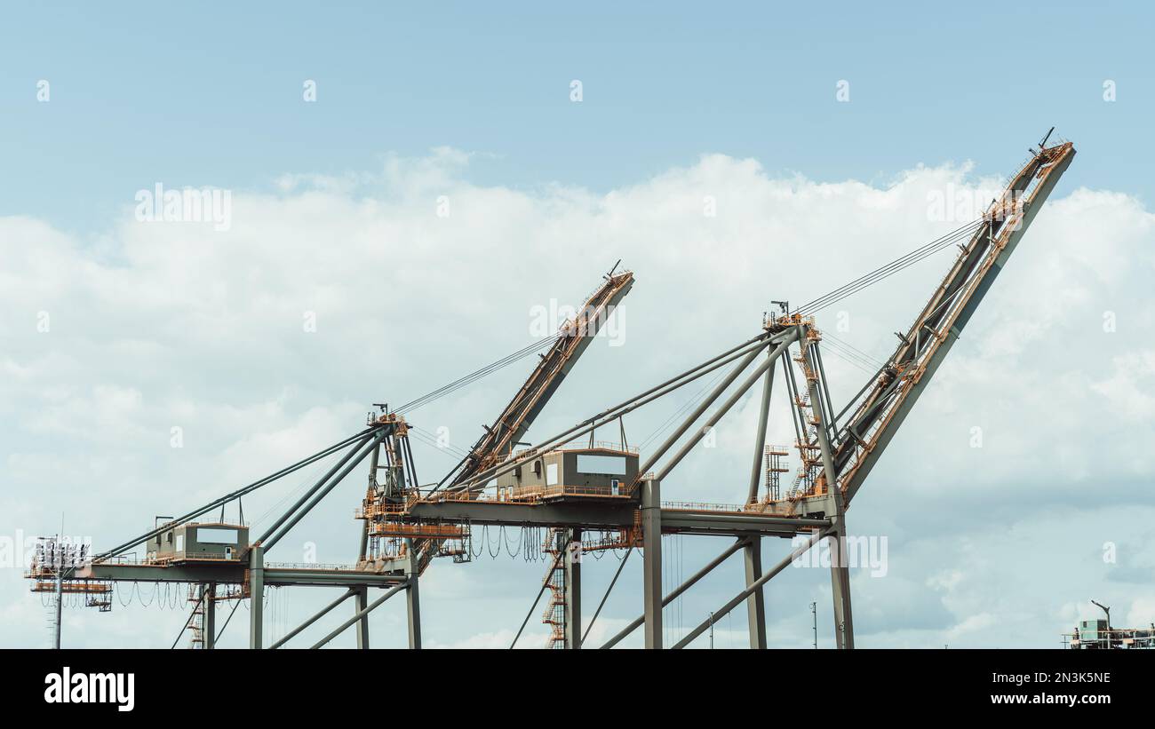Scene of a couple of huge yellow container handling cranes at a port at ...