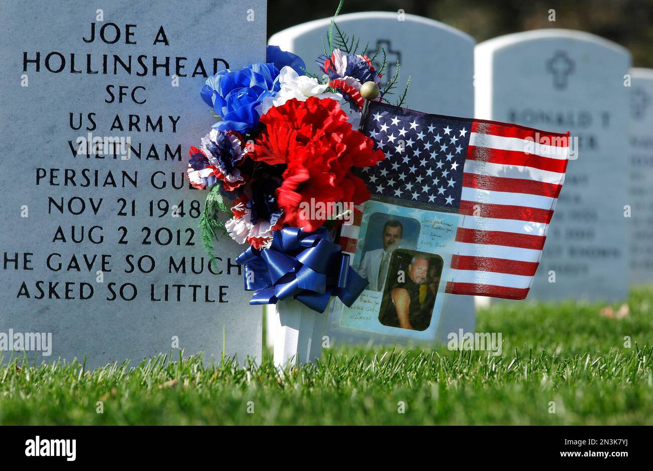 An American flag and memorial is placed on the burial site of Joe ...