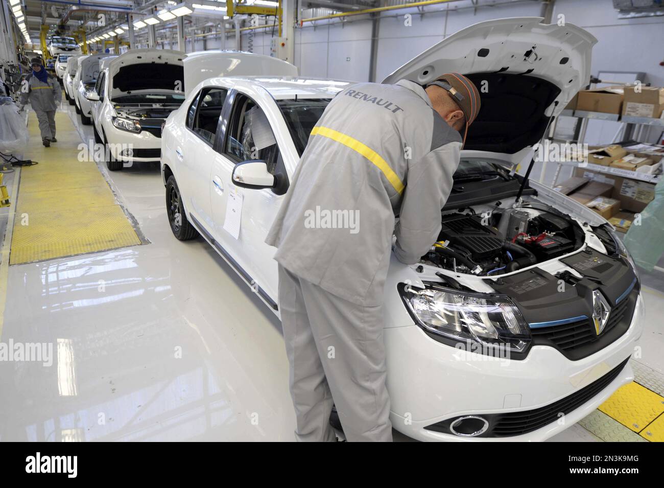 Employees work at the assembly line in the new Renault plant in Oran ...