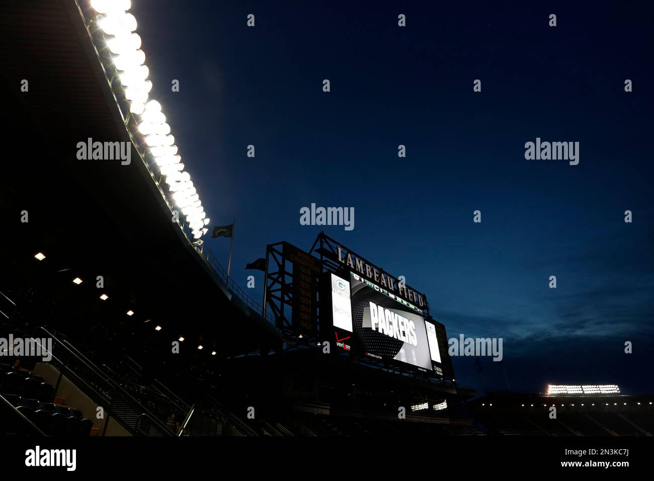 Lights shine against the dark blue sky at Lambeau Field before of an ...
