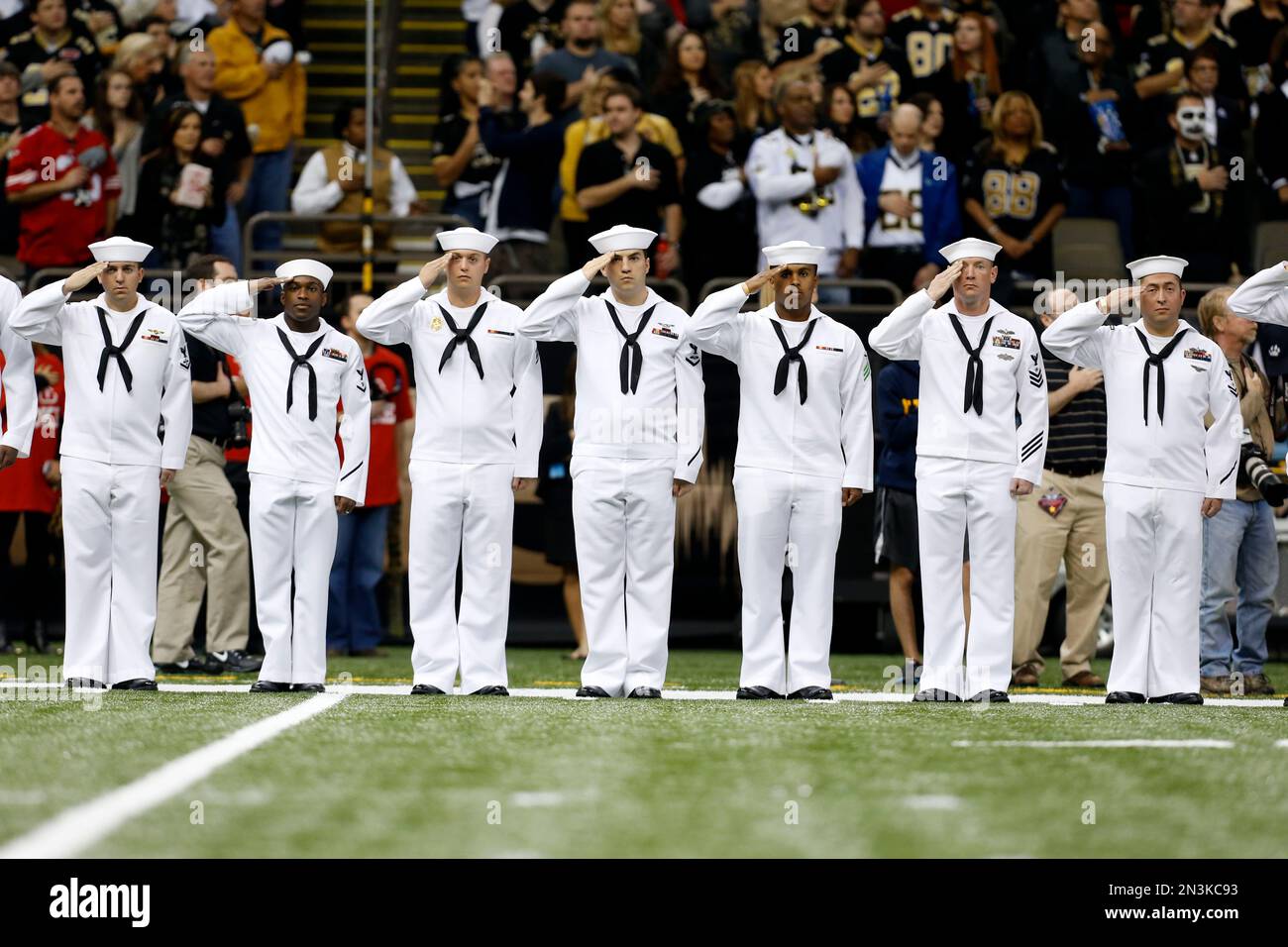 Servicemen salute during the National Anthem as part of Salute to ...