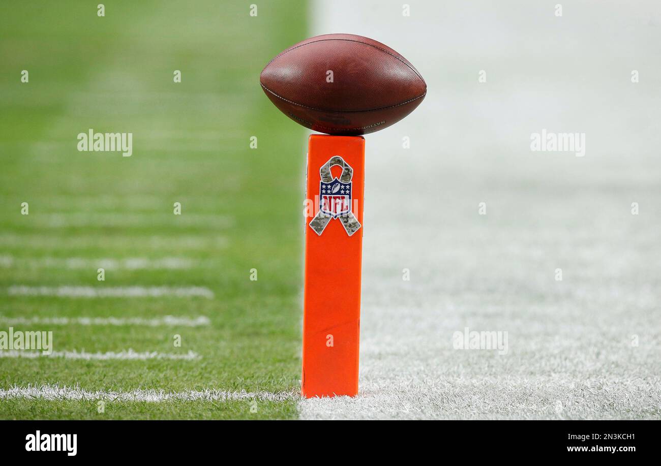 A football balances on an end zone pylon prior to an NFL football game ...