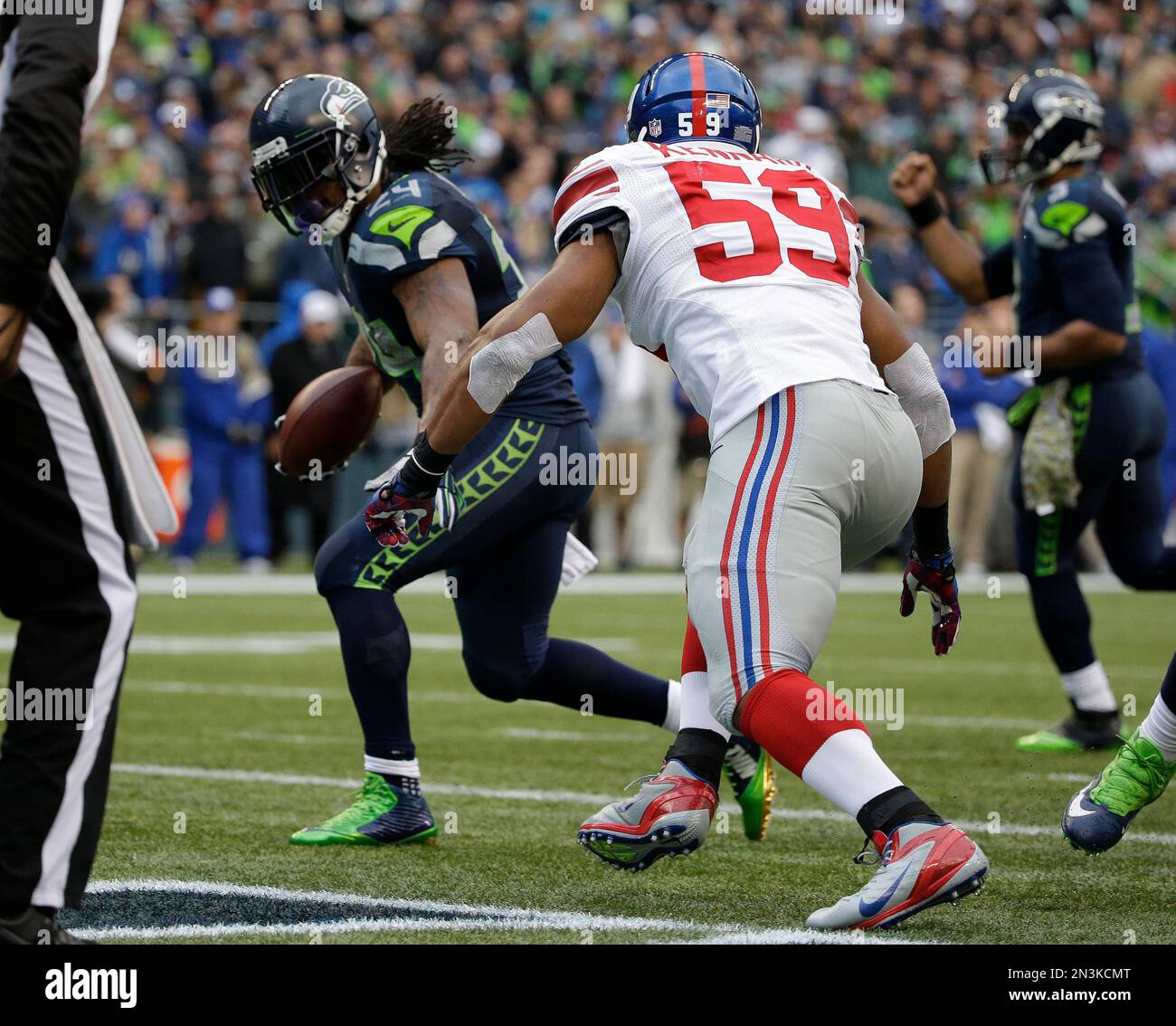 Seattle Seahawks' Marshawn Lynch, left, scores as New York Giants ...