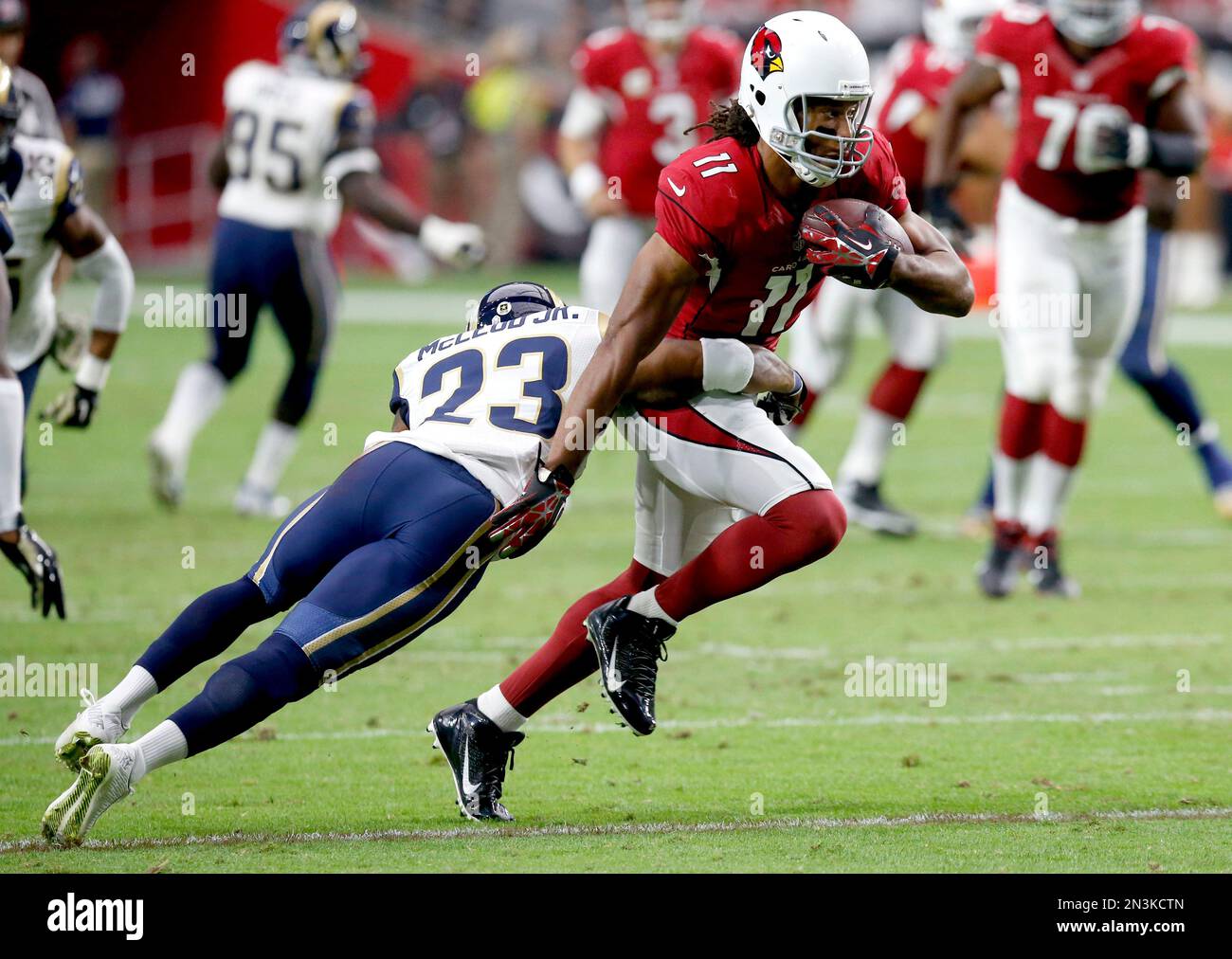 Arizona Cardinals wide receiver Larry Fitzgerald (11) is hit by St ...