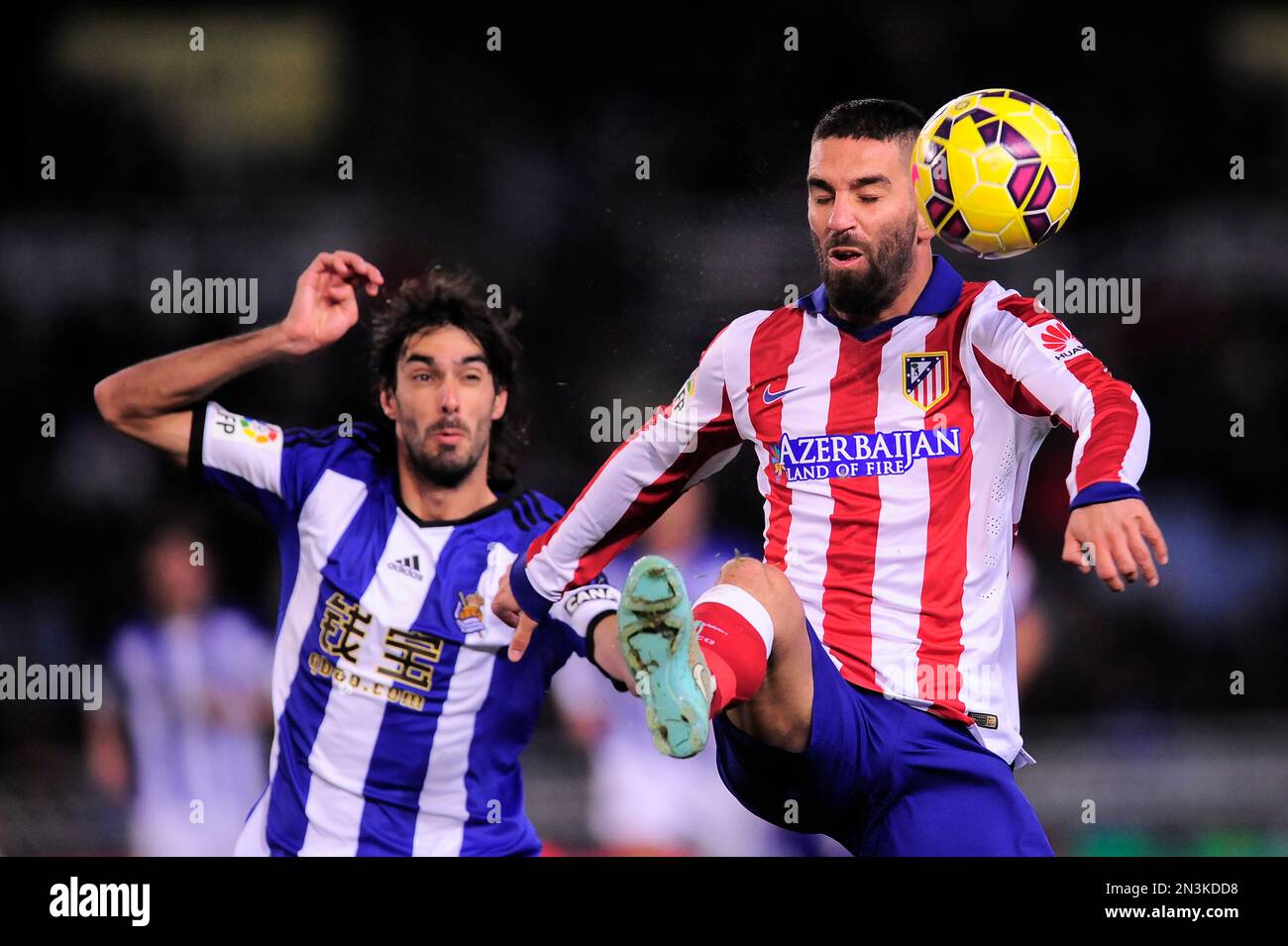 Atletico de Madrid's Arda Turan of Turkey, right, controls the ball in ...