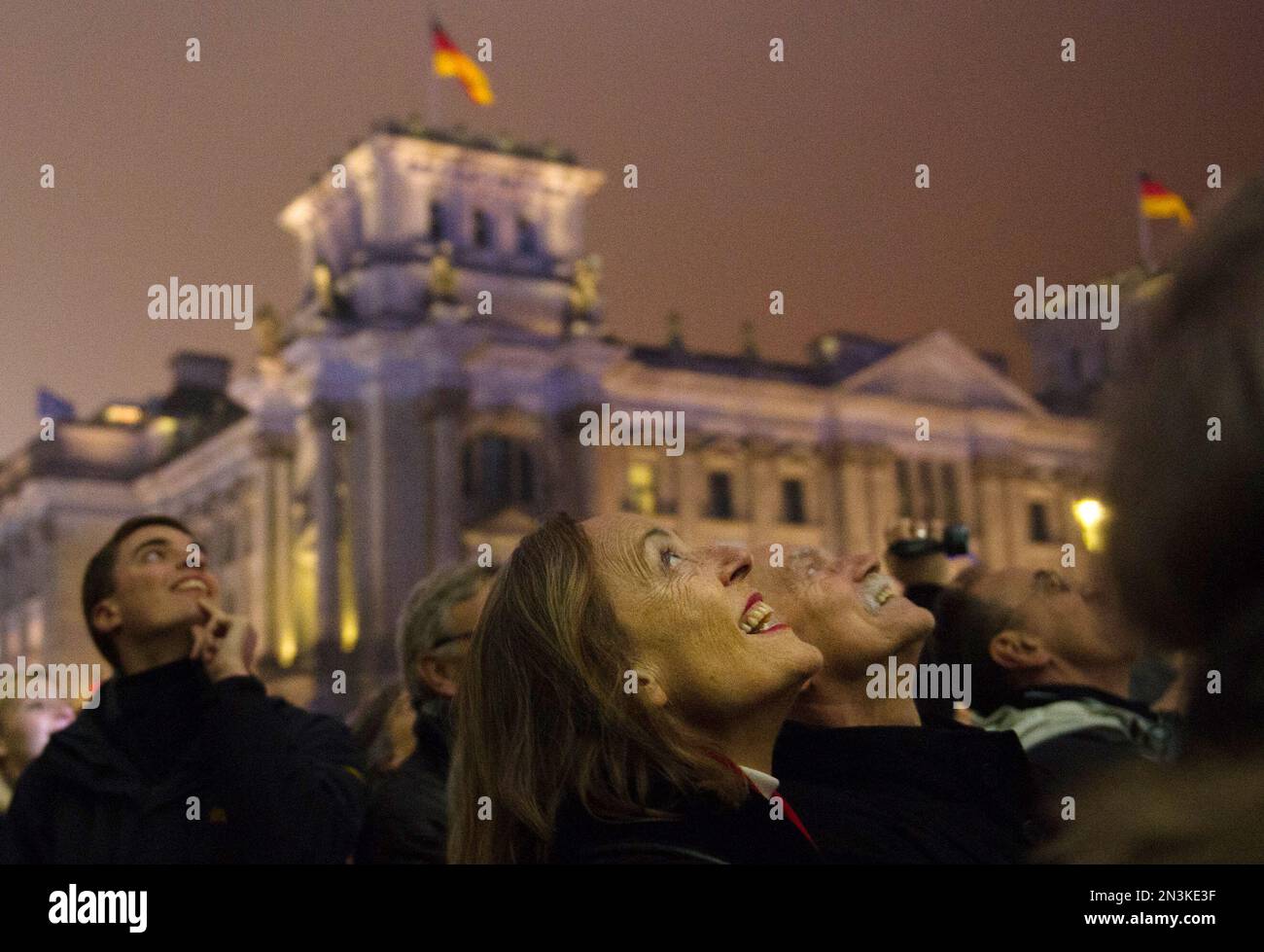 People watch balloons marking the former border flying away in front of ...