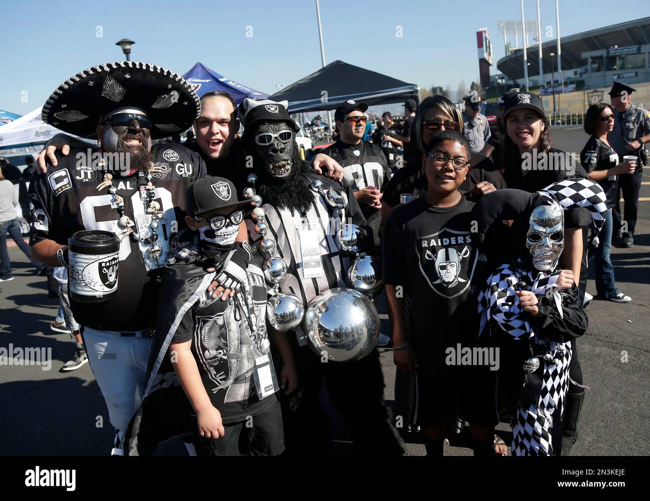 Oakland Raiders fans pose for photos while tailgating in the O.co ...