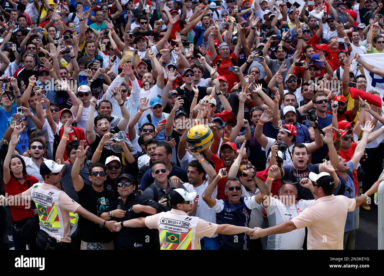 Security guards hold back fans that invaded the track to celebrate the ...