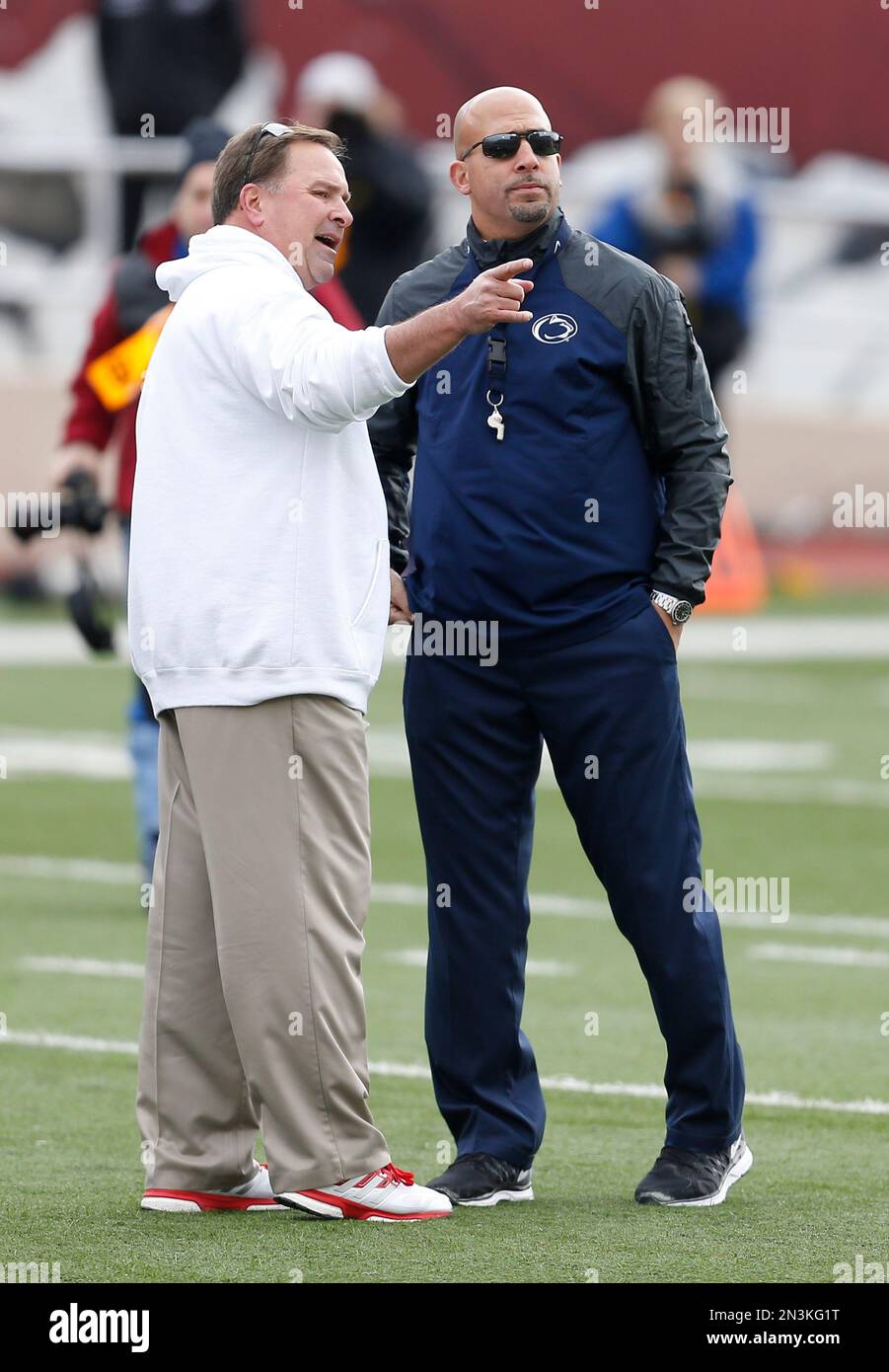Indiana head coach Kevin Wilson talks with Penn State head coach James ...