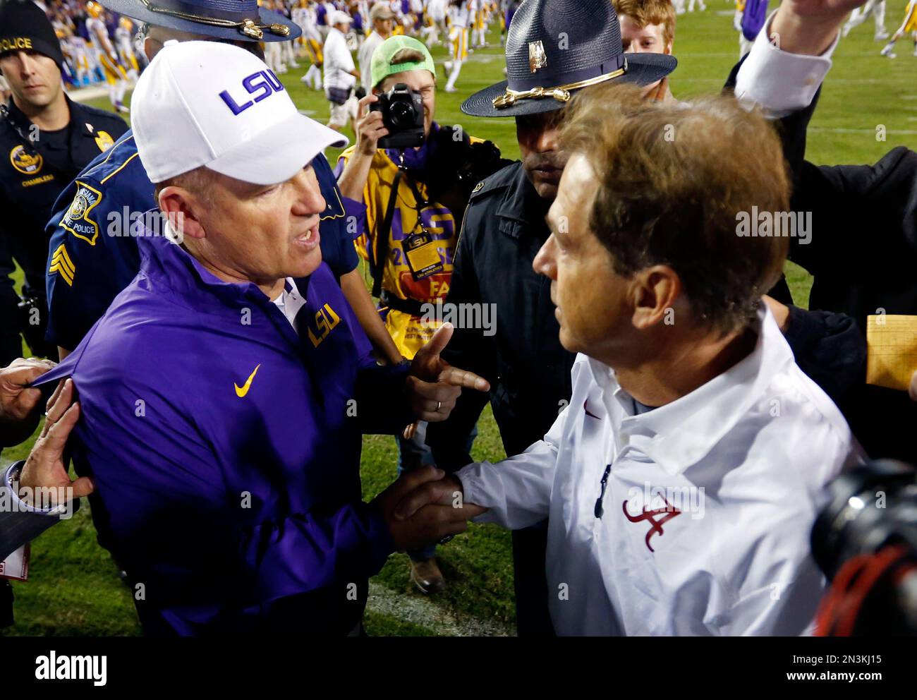 LSU coach Les Miles, left, shakes hands with Alabama coach Nick Saban ...