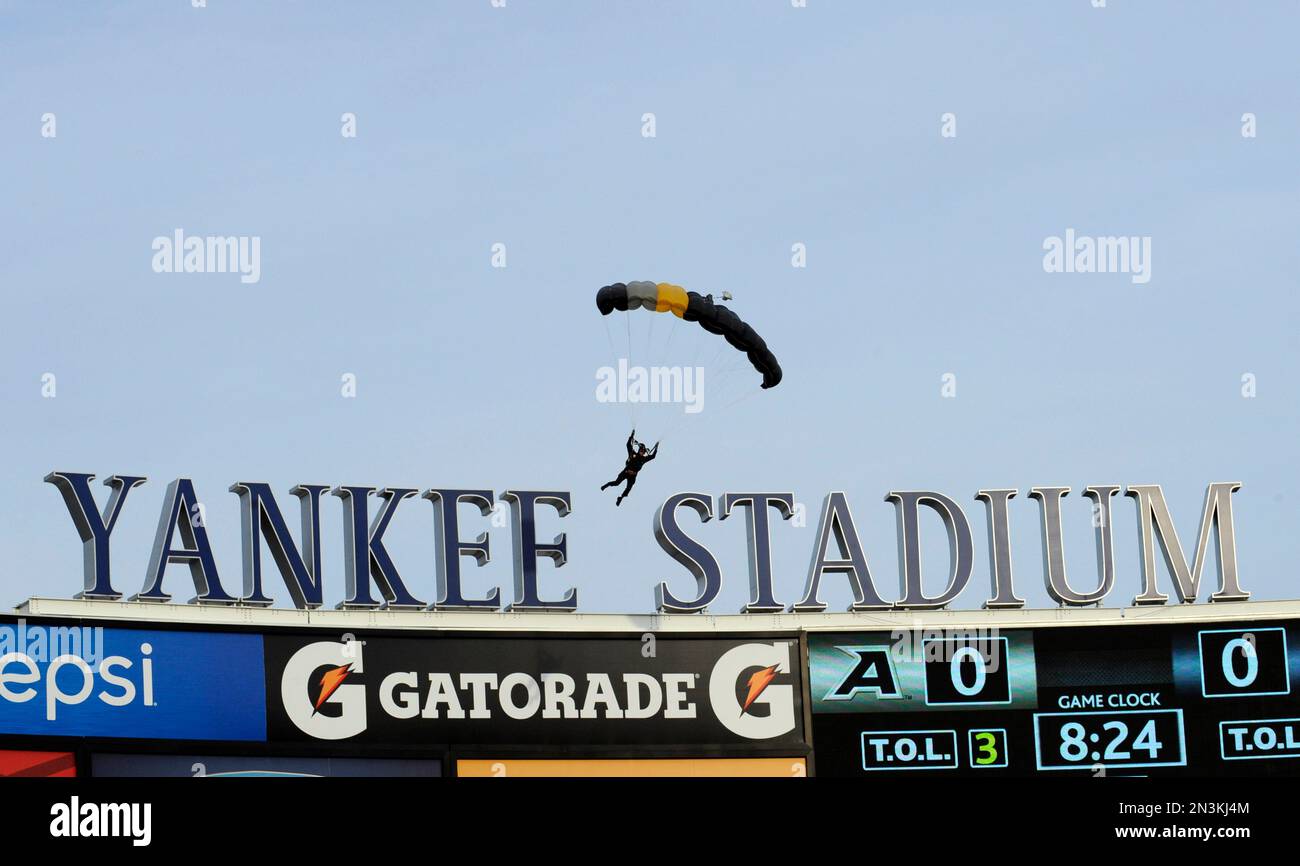 The West Point parachute team parachutes into Yankee Stadium before ...