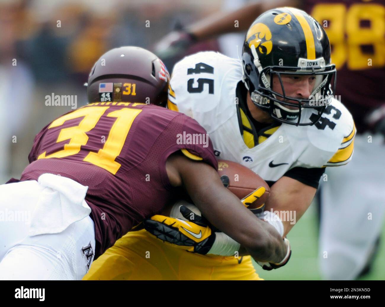 Minnesota defensive back Eric Murray (31) tackles Iowa running back ...