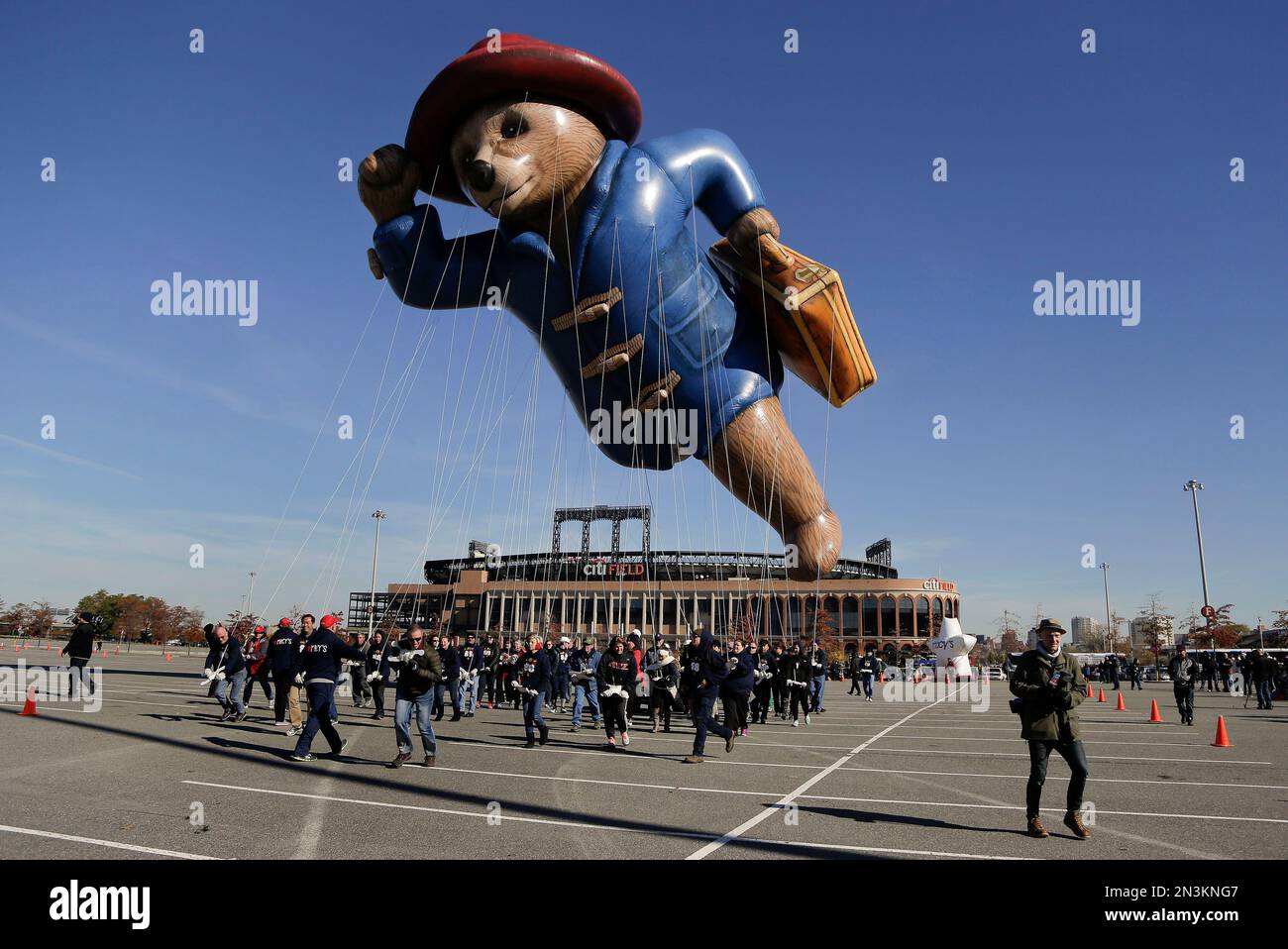 The Paddington balloon floats above its handlers as they take it for a ...