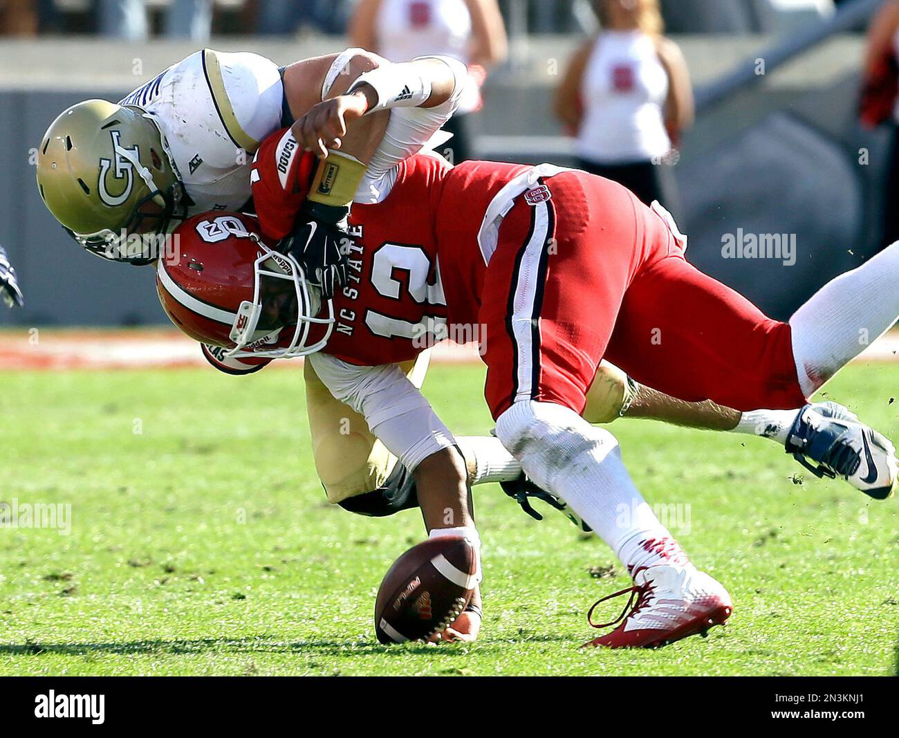 North Carolina State quarterback Jacoby Brissett (12) fumbles the ball ...