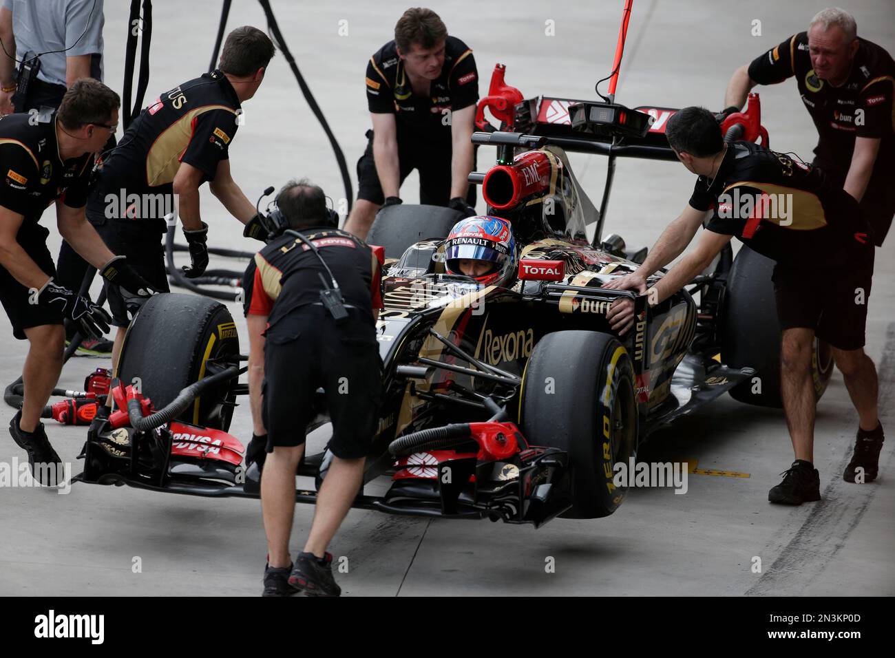 Lotus driver Romain Grosjean, of France, returns to pits after the ...