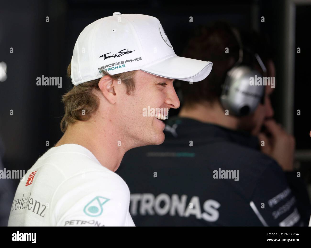 Mercedes driver Nico Rosberg, of Germany, stand in his team's garage ...