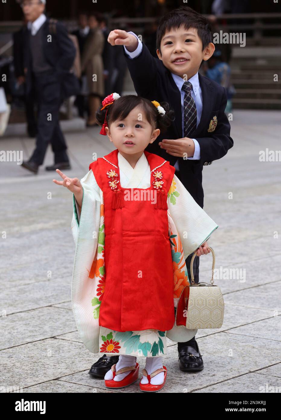 A kimono-clad girl poses during an annual festival at Meiji Jingu ...