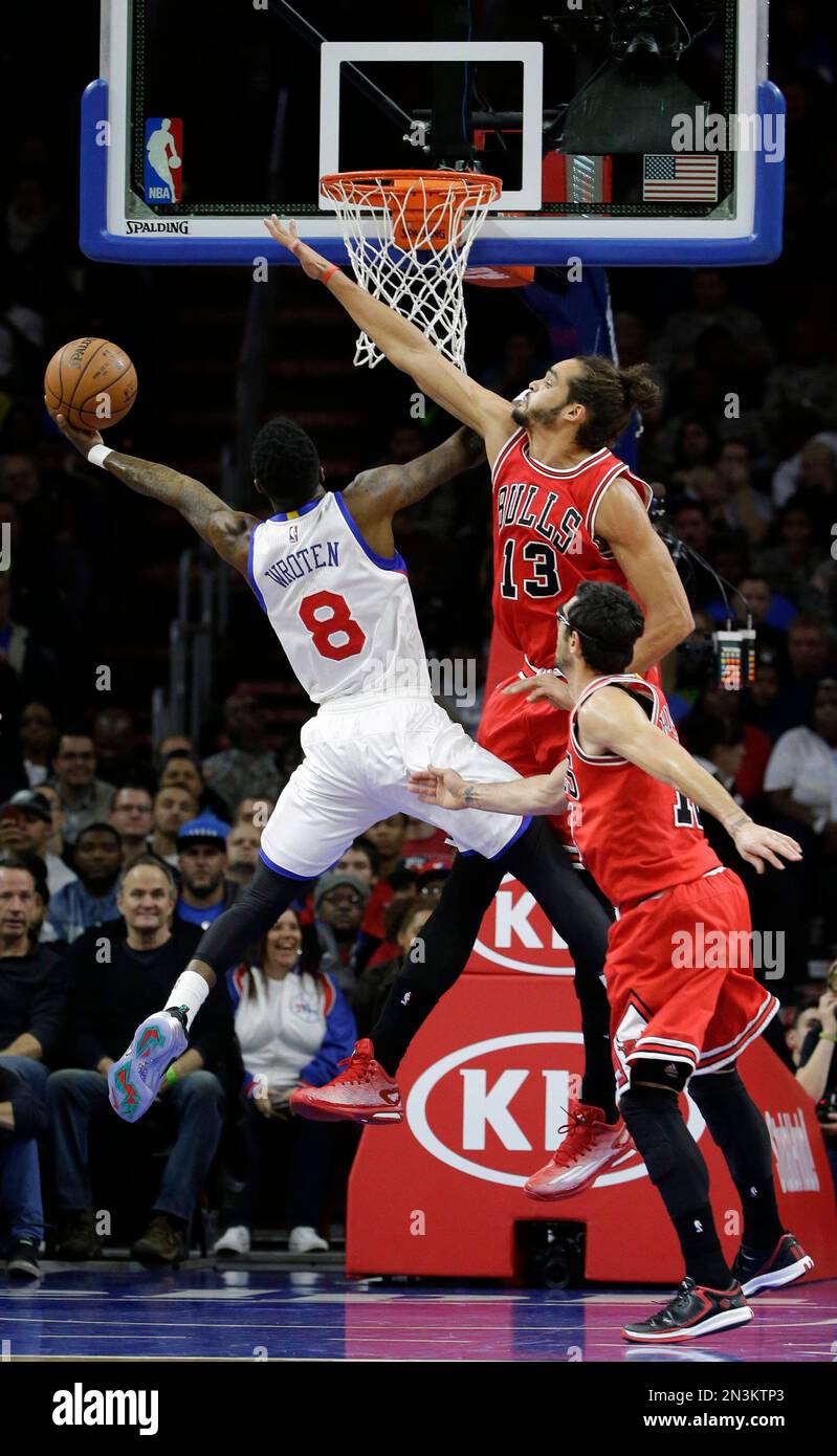 Philadelphia 76ers' Tony Wroten, left, goes up to shoot against Chicago ...