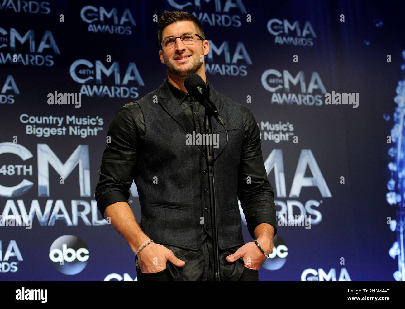 Tim Tebow poses in the press room at the 48th annual CMA Awards at the ...